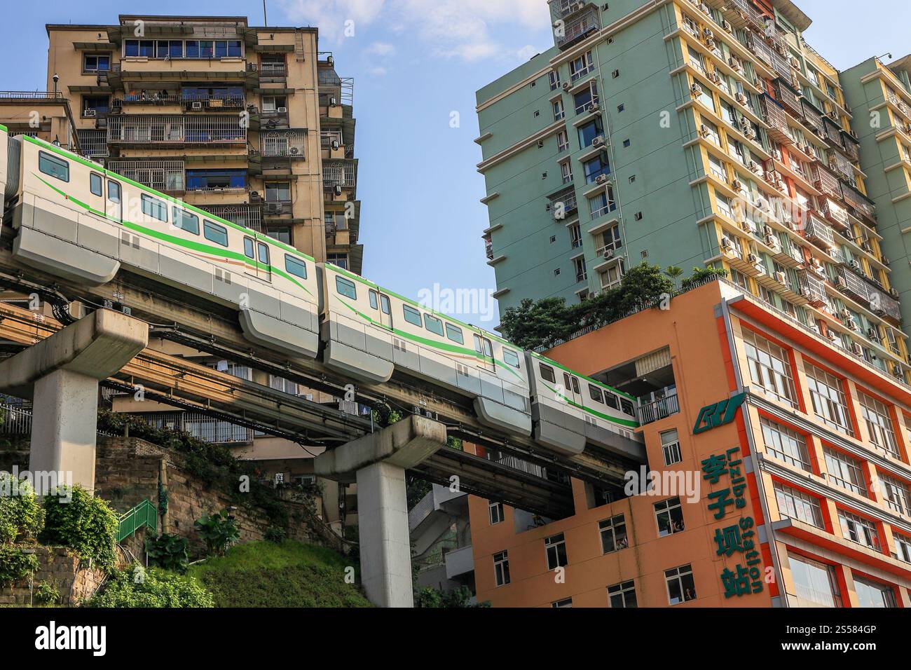 Chongqing, China - October 20. 2023: Monorail Metro Passing Through a high-rise residential ...