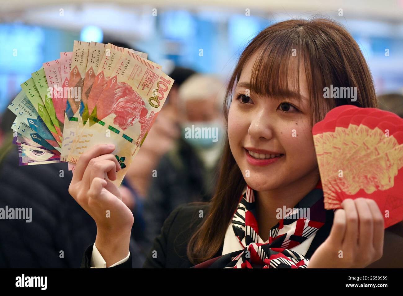 Hong Kong,China.14th January 2025. A bank clerk shows new Hong Kong ...