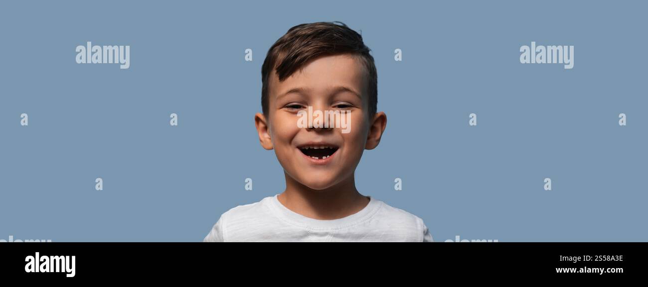 Cute boy without front teeth laughs. Changing teeth and hygiene. Close ...