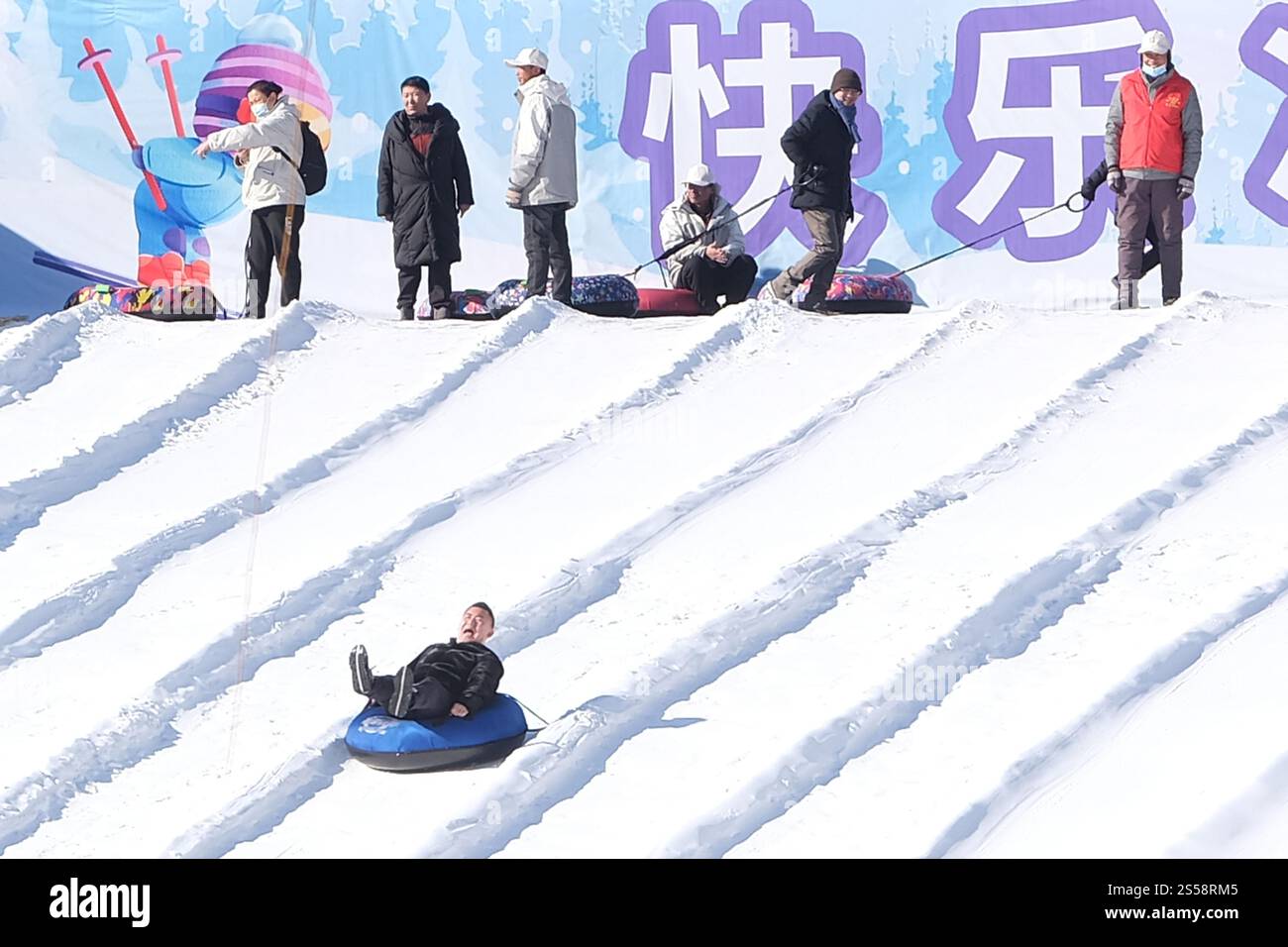 Tourists experience ice and snow sports at a park in Beijing, China, 10 ...