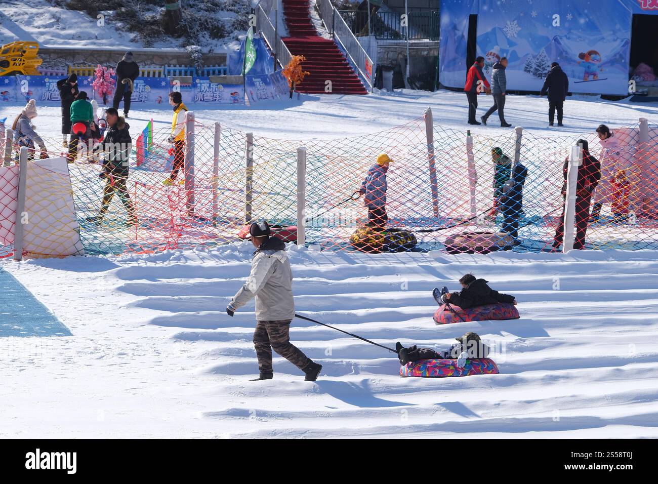 Tourists experience ice and snow sports at a park in Beijing, China, 10 ...