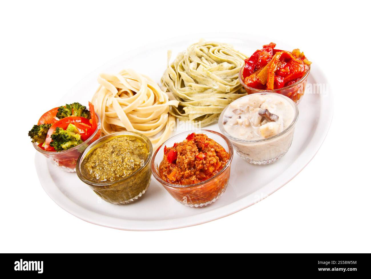 two choices of pasta and various spices on plate. two italian ...