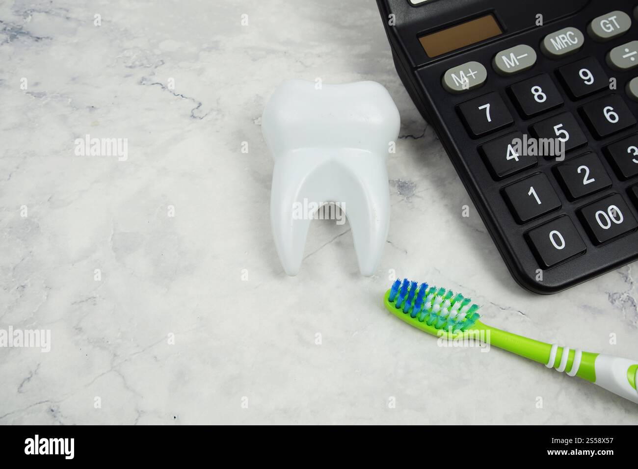 Toothbrush and Tooth with calculator top view on marble background ...