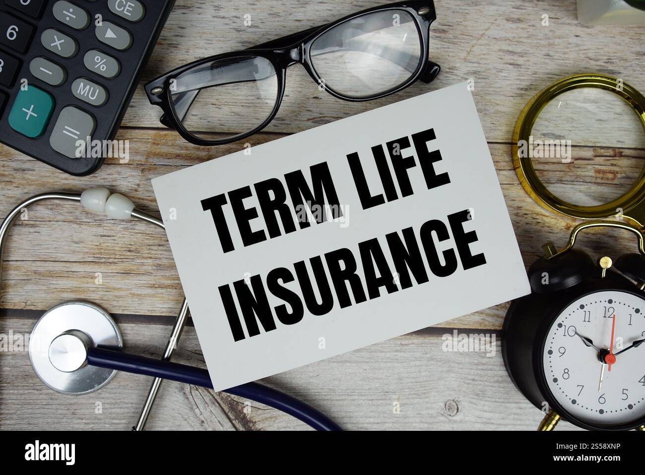 Term Life Insurance text with calculator, magnifying glass and alarm ...
