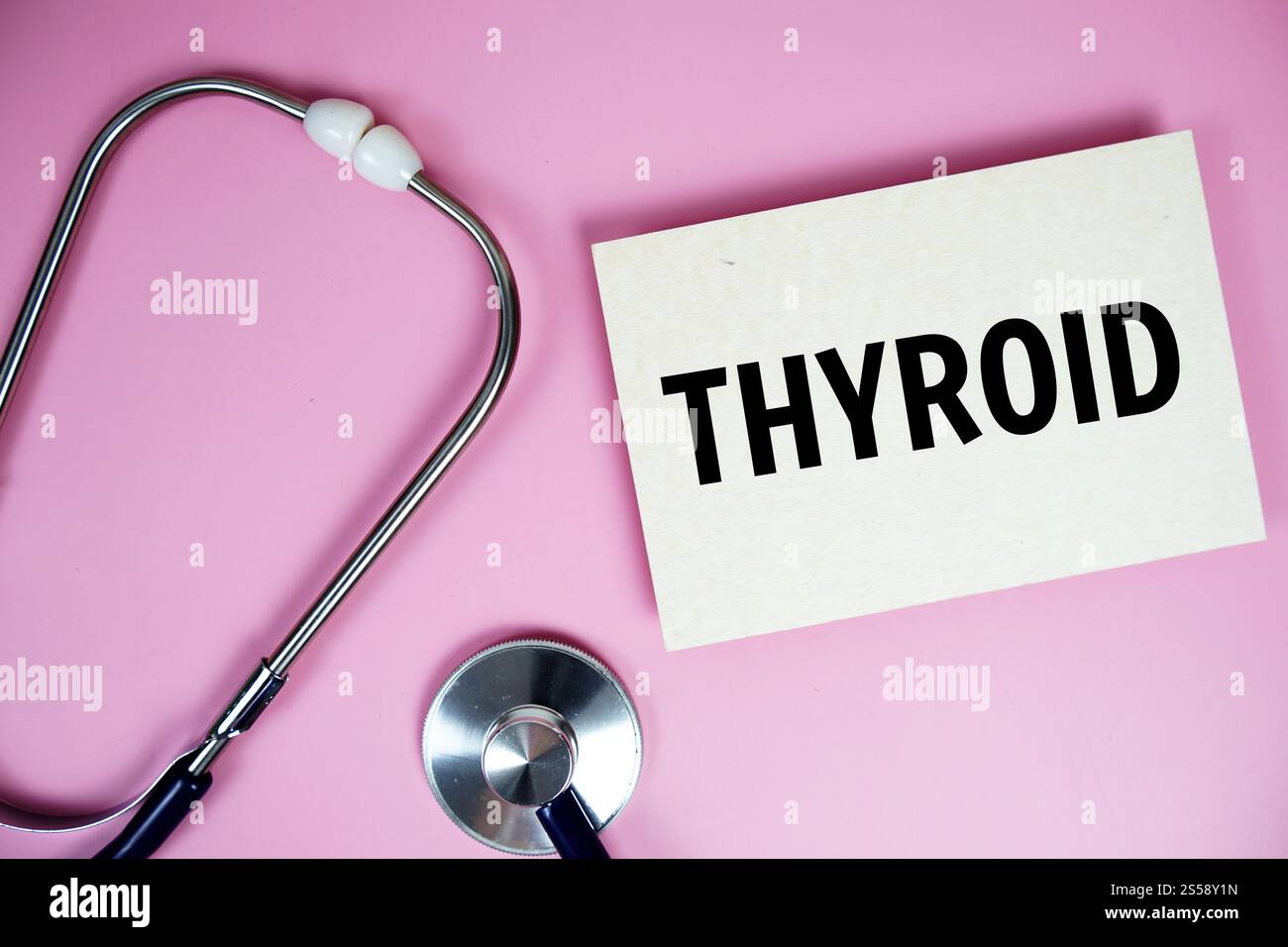 Thyroid text with stethoscope on pink background, Healthy and wellness ...