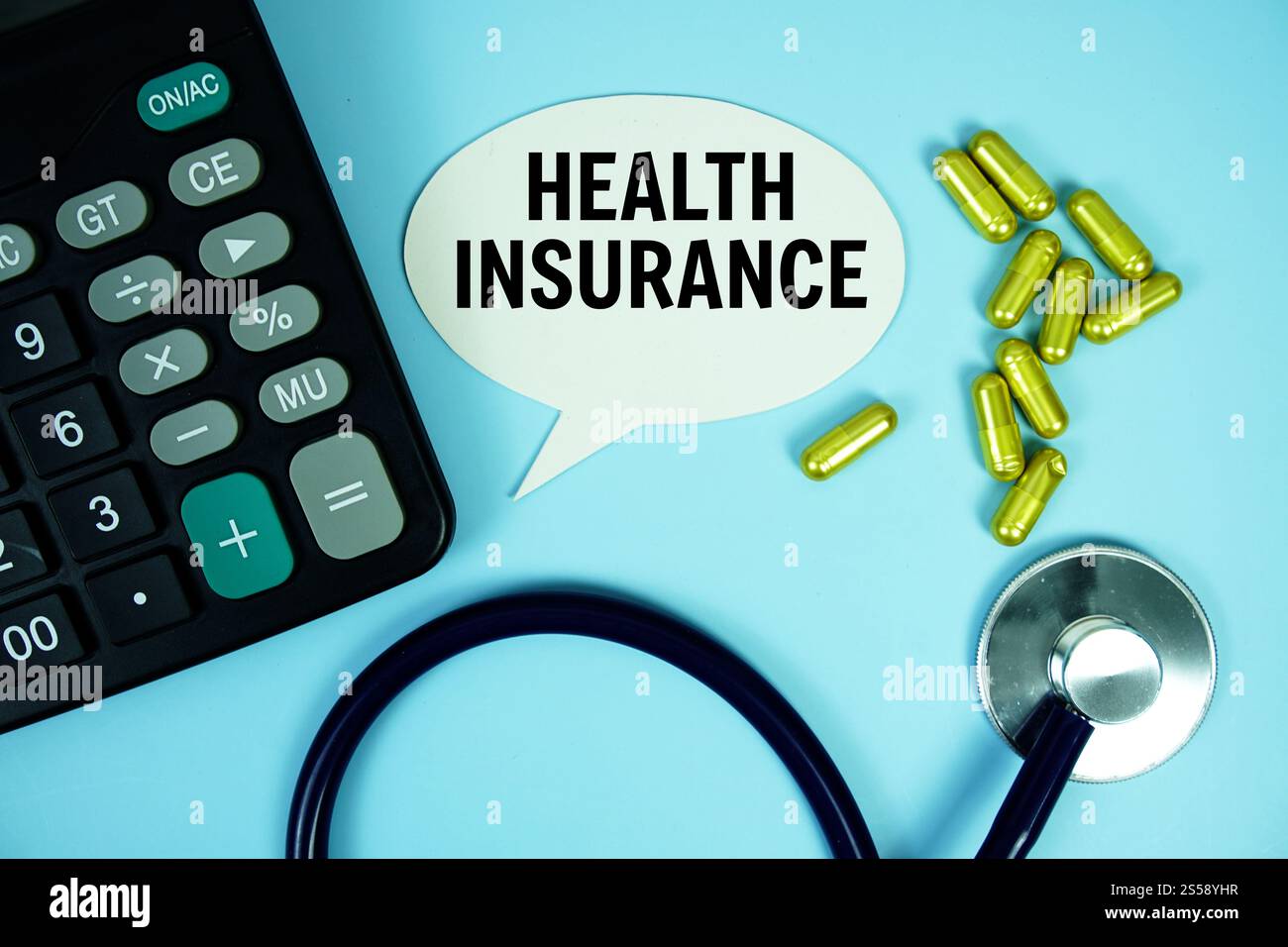 Health Insurance text with stethoscope, calculator and capsule medicine ...