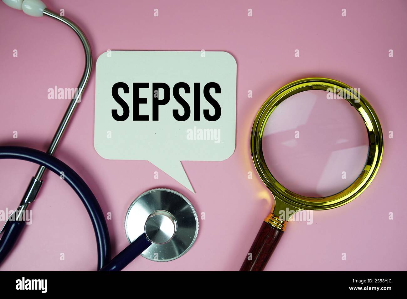 Sepsis text with stethoscope and magnifying glass on pink background ...