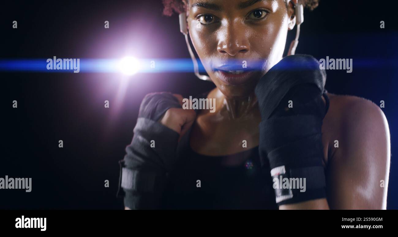 Woman, boxer fighter and studio for practice, sweating and lens flare ...