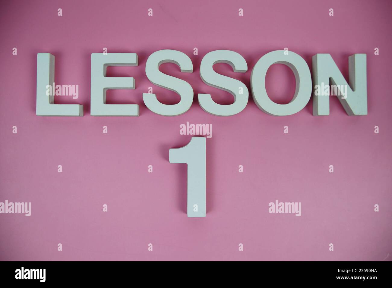Lesson 1 Lesson One alphabet letters on pink background Stock Photo - Alamy