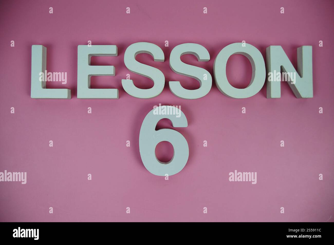 Lesson 6 Lesson Six alphabet letters on pink background Stock Photo - Alamy