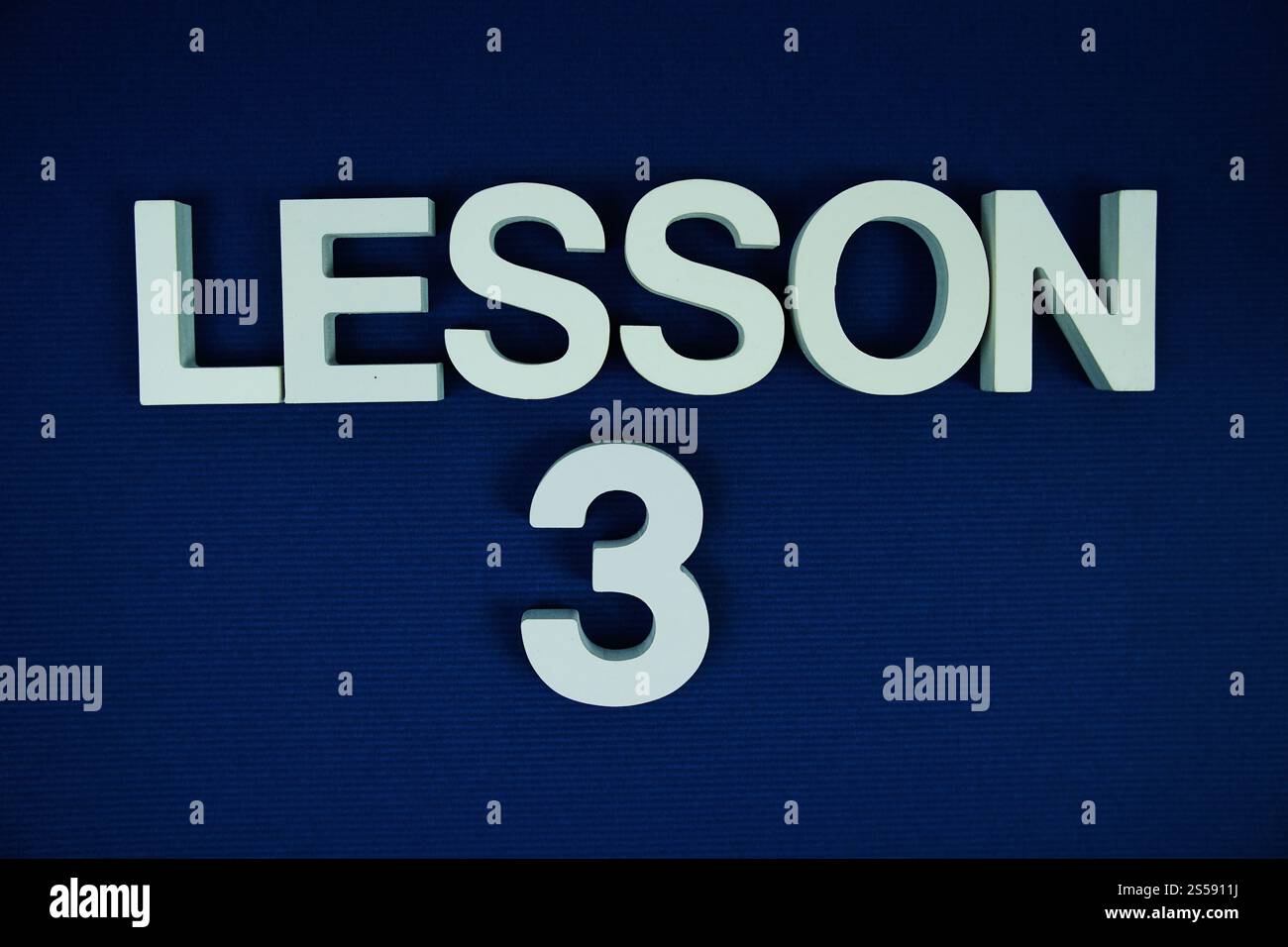 Lesson 3 Lesson Three alphabet letters on navy blue background Stock Photo - Alamy