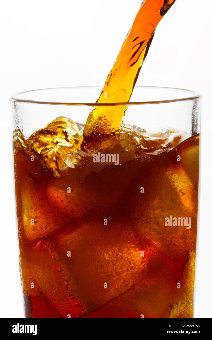 Cola is pouring into glass on white background. Cola is pouring into ...