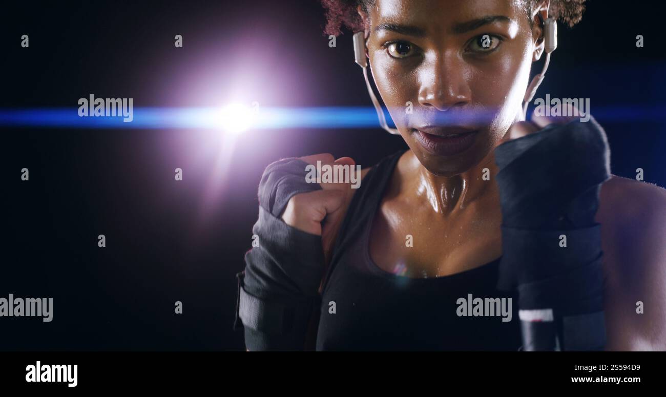 Woman, boxer fighter and studio for challenge, sweating and lens flare ...