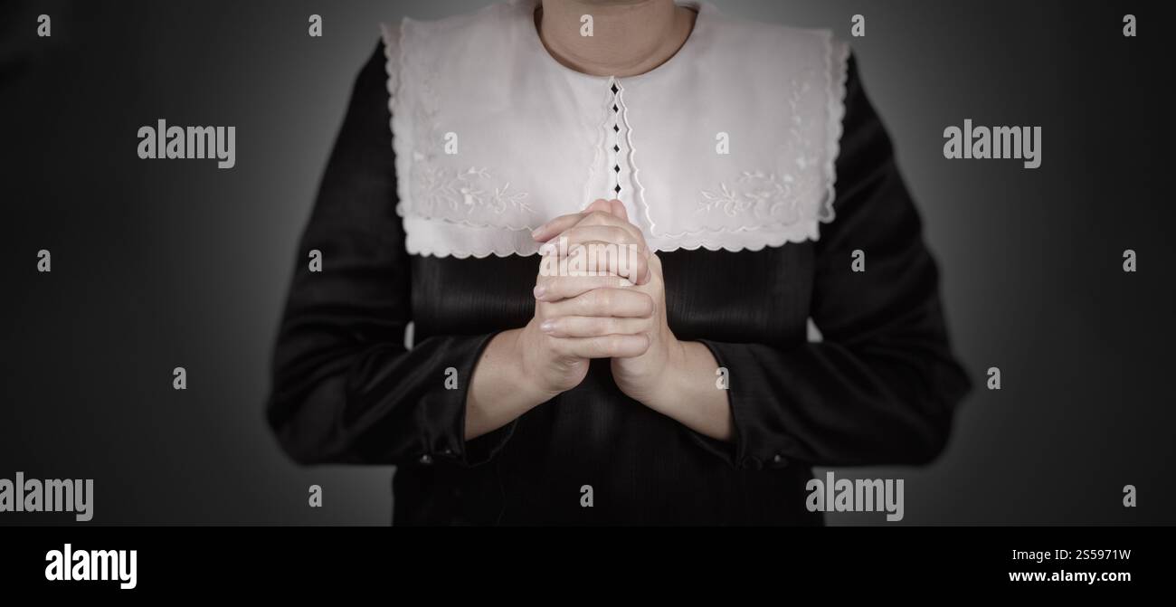 hand of nun praying on black background Stock Photo - Alamy