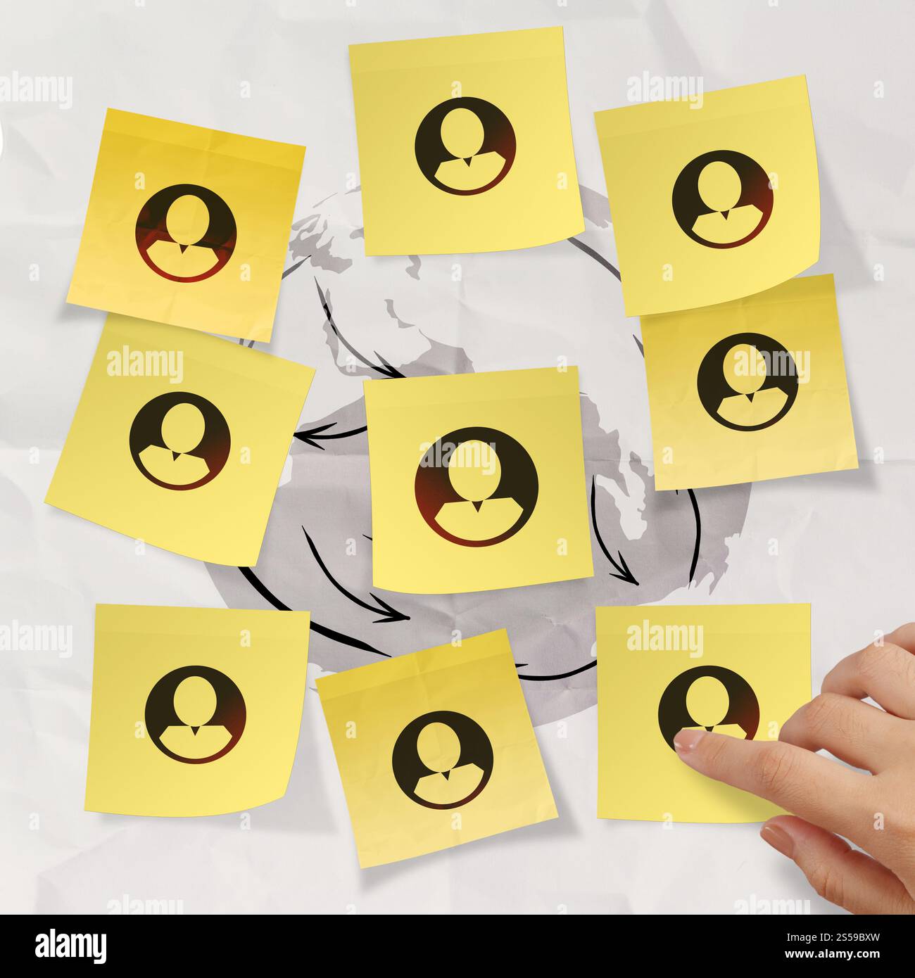 hand pushing sticky note social network icon on crumpled paper ...