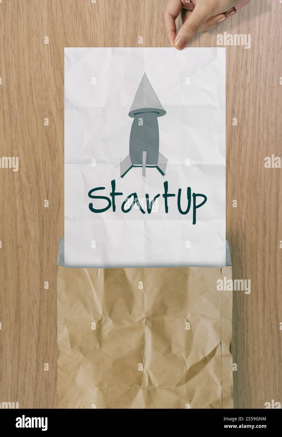 business hand pull wrinkled paper show word start up word icon as ...