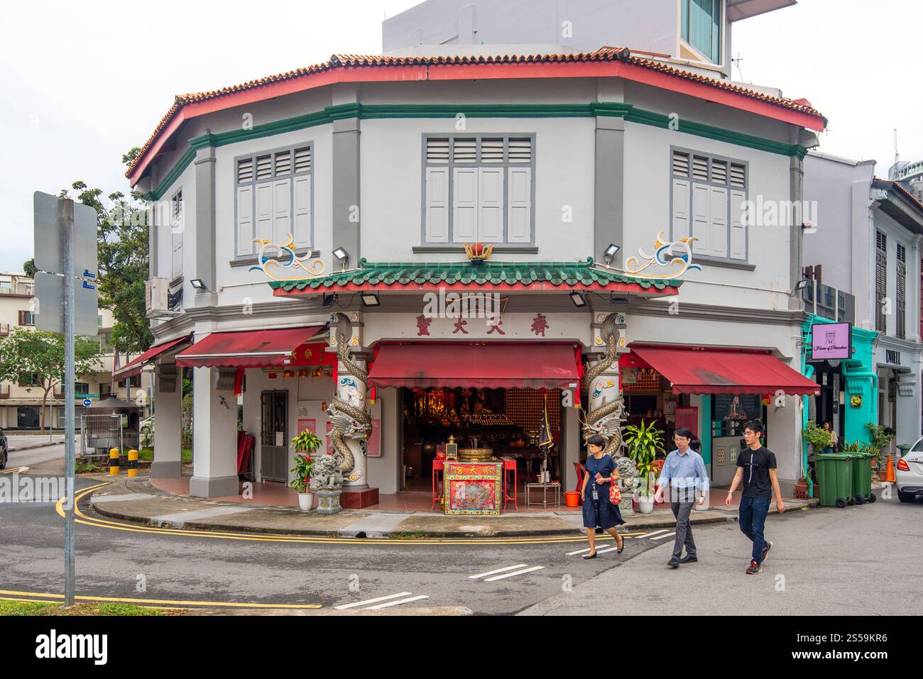 People walking past the Tiong Bahru Qi Tian Gong or Monkey God Temple ...