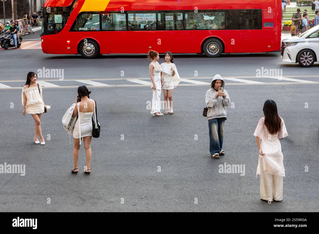 Young Vietnamese women taking selfies of each other in the street in Ho ...
