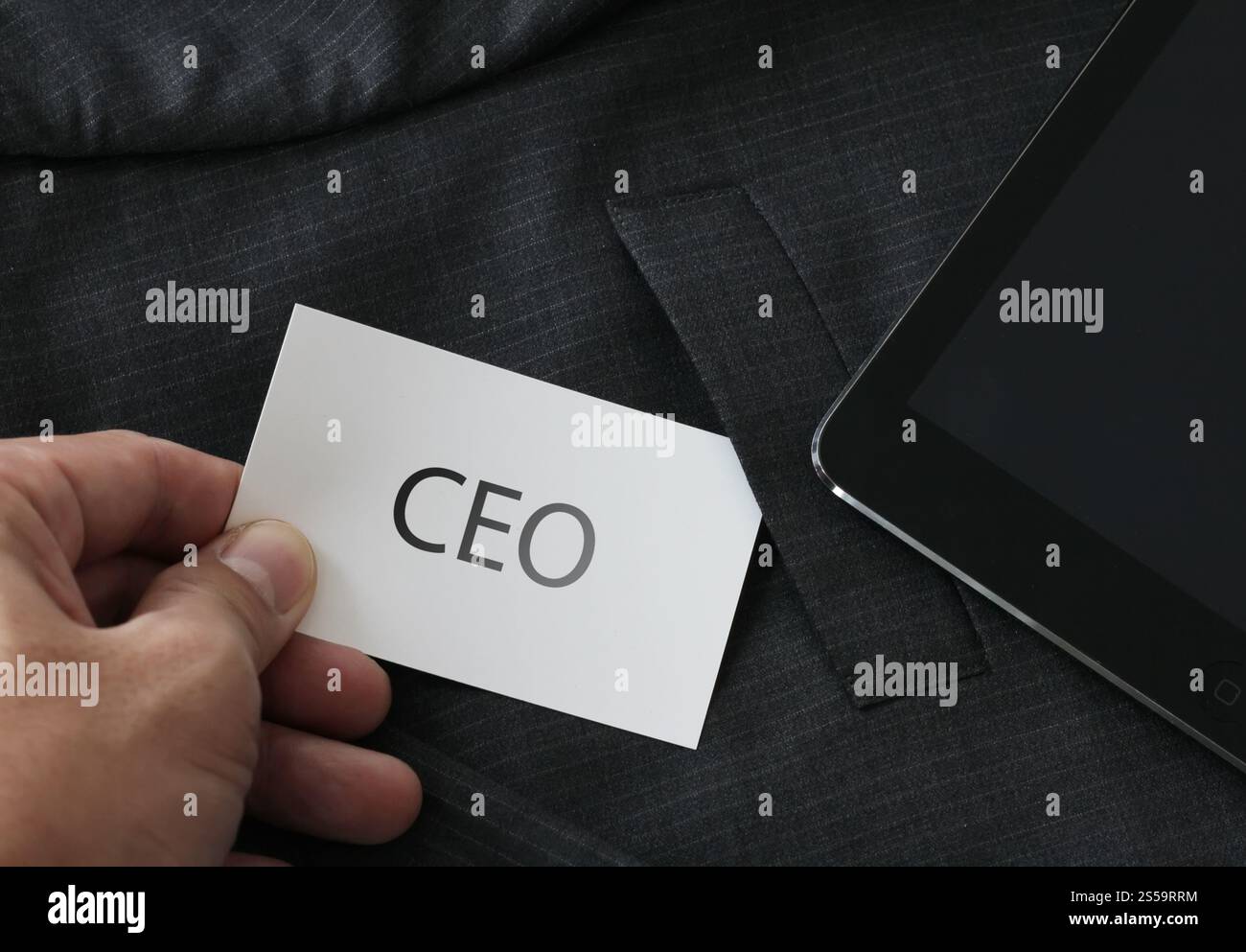 close up of businessman hand picking business card reading CEO from the ...