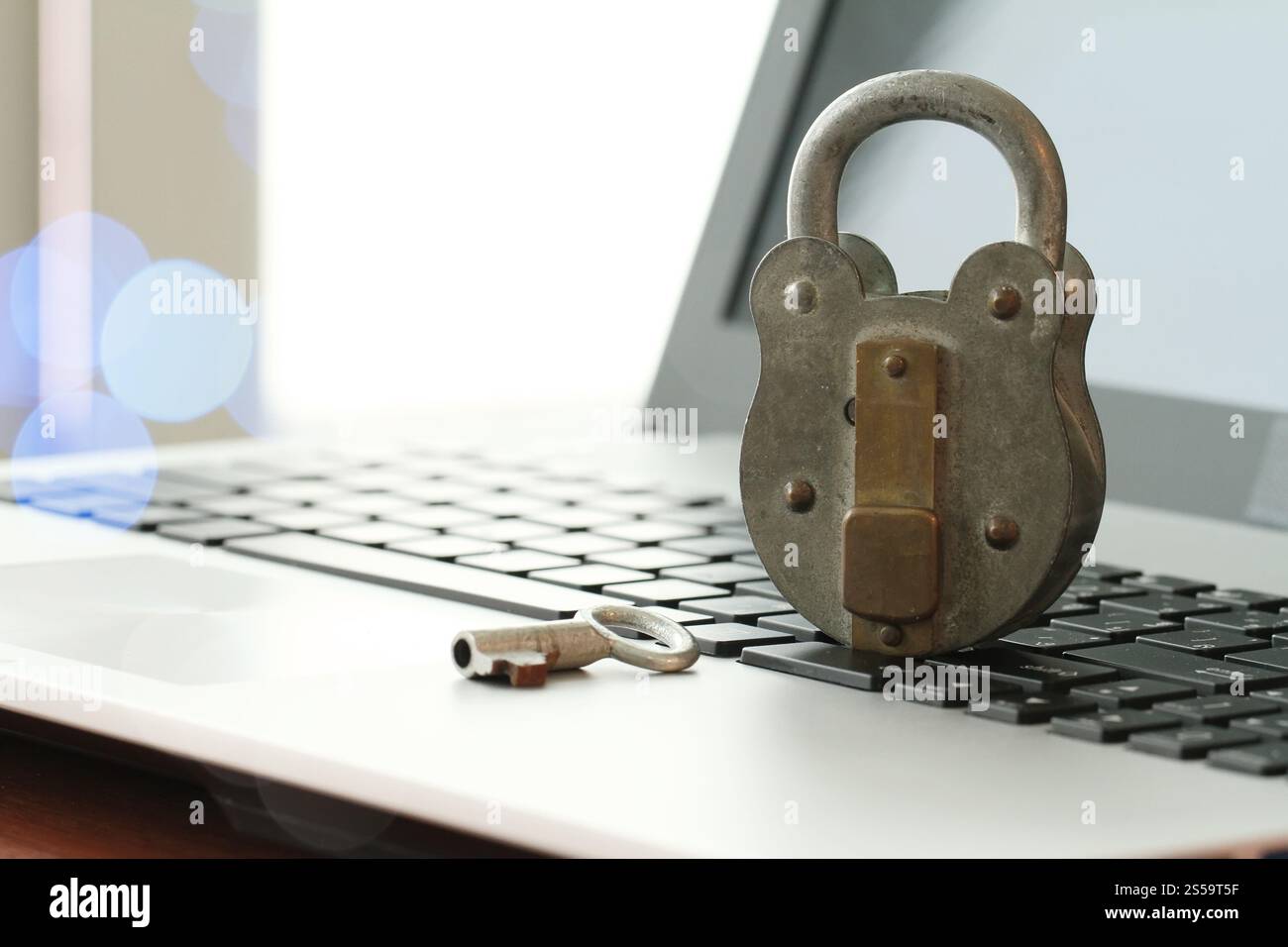 Internet security concept-old padlock and key on laptop computer ...