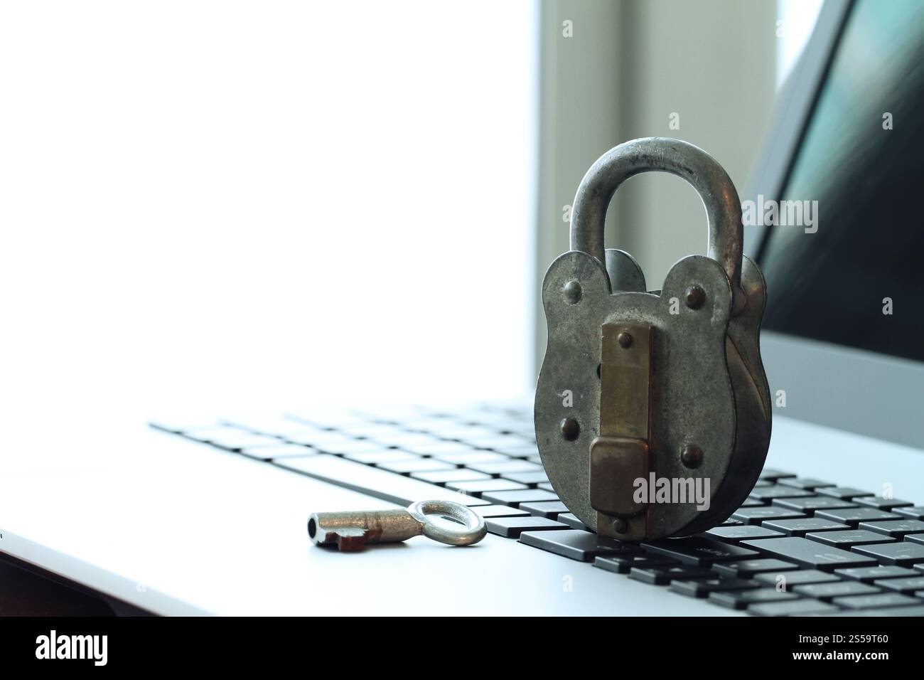 Internet security concept-old padlock and key on laptop computer ...