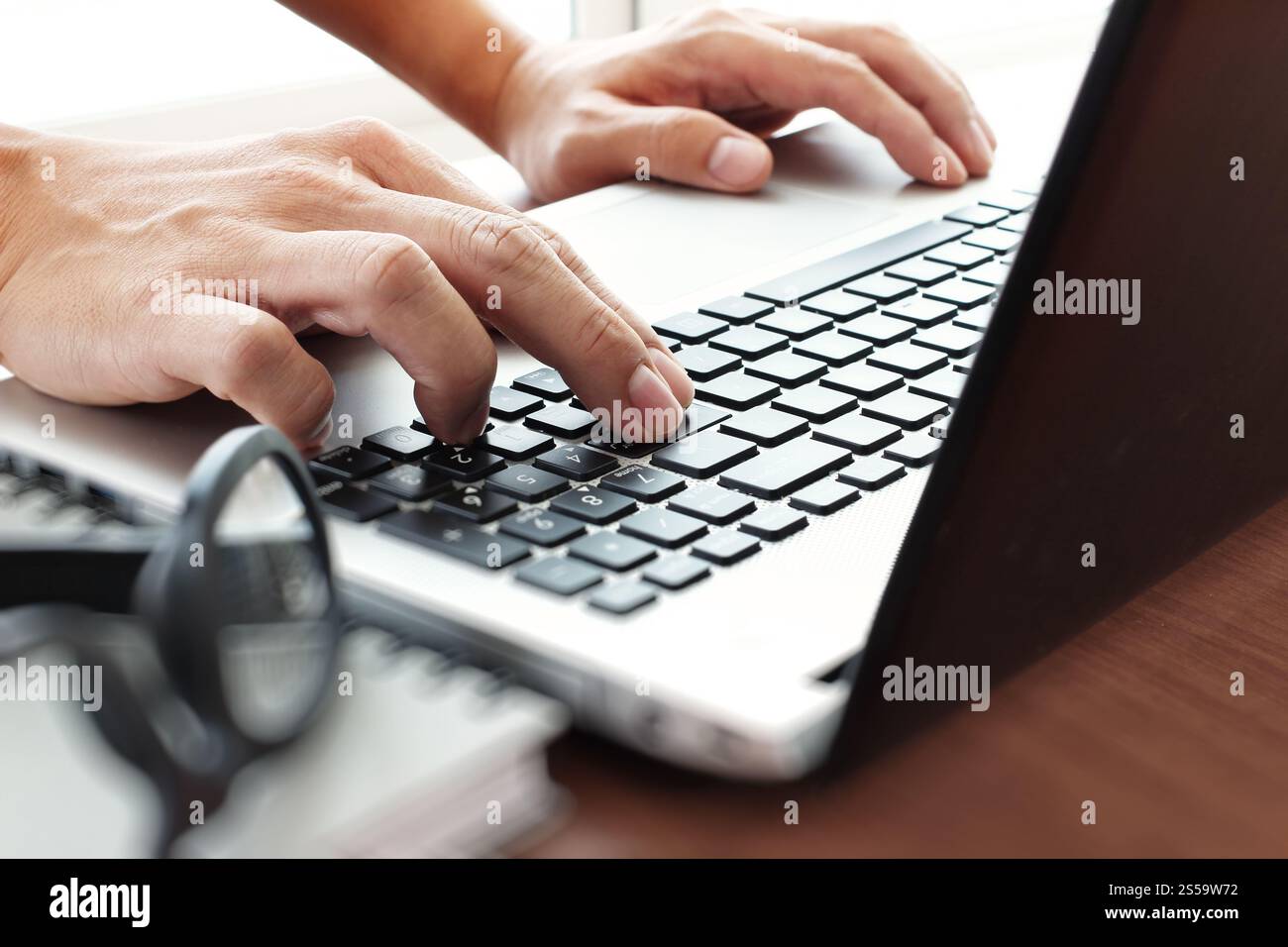 Close up of business man hand working on blank screen laptop computer ...