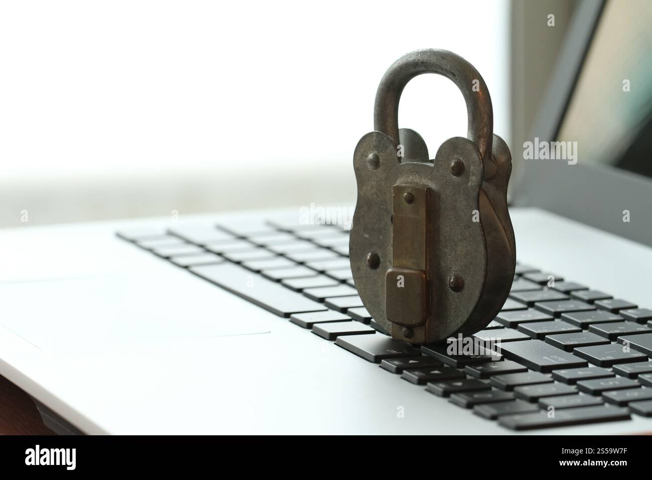 Internet security concept-old padlock and key on laptop computer ...