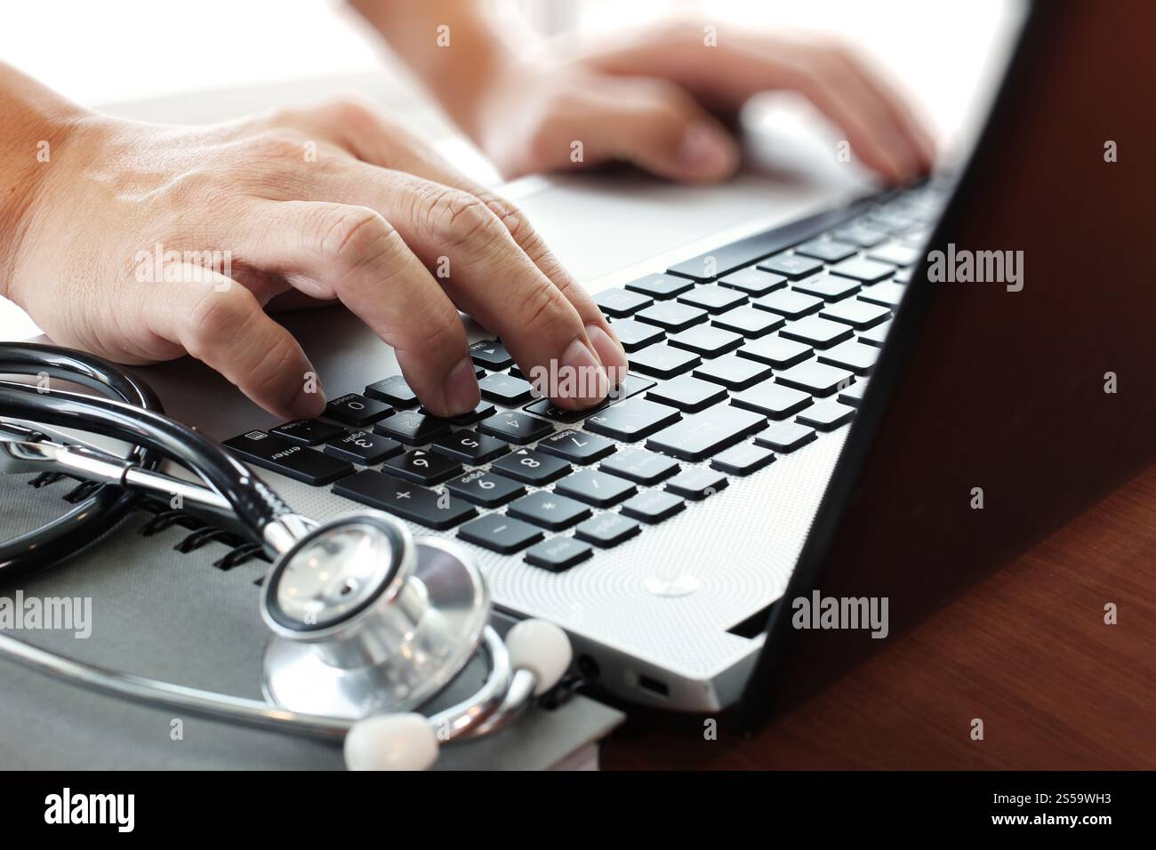 Doctor working with laptop computer in medical workspace office as ...