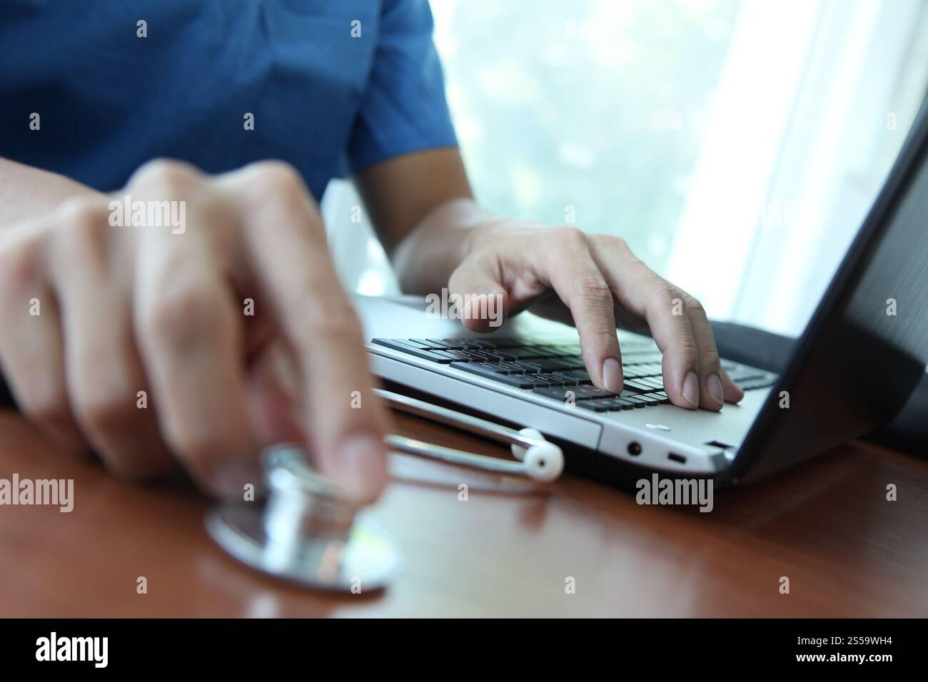 Doctor working with laptop computer in medical workspace office as ...