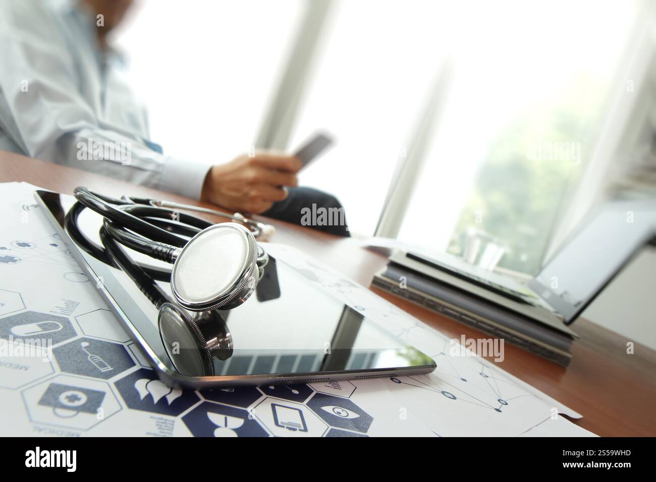 Doctor working with digital tablet and laptop computer in medical ...