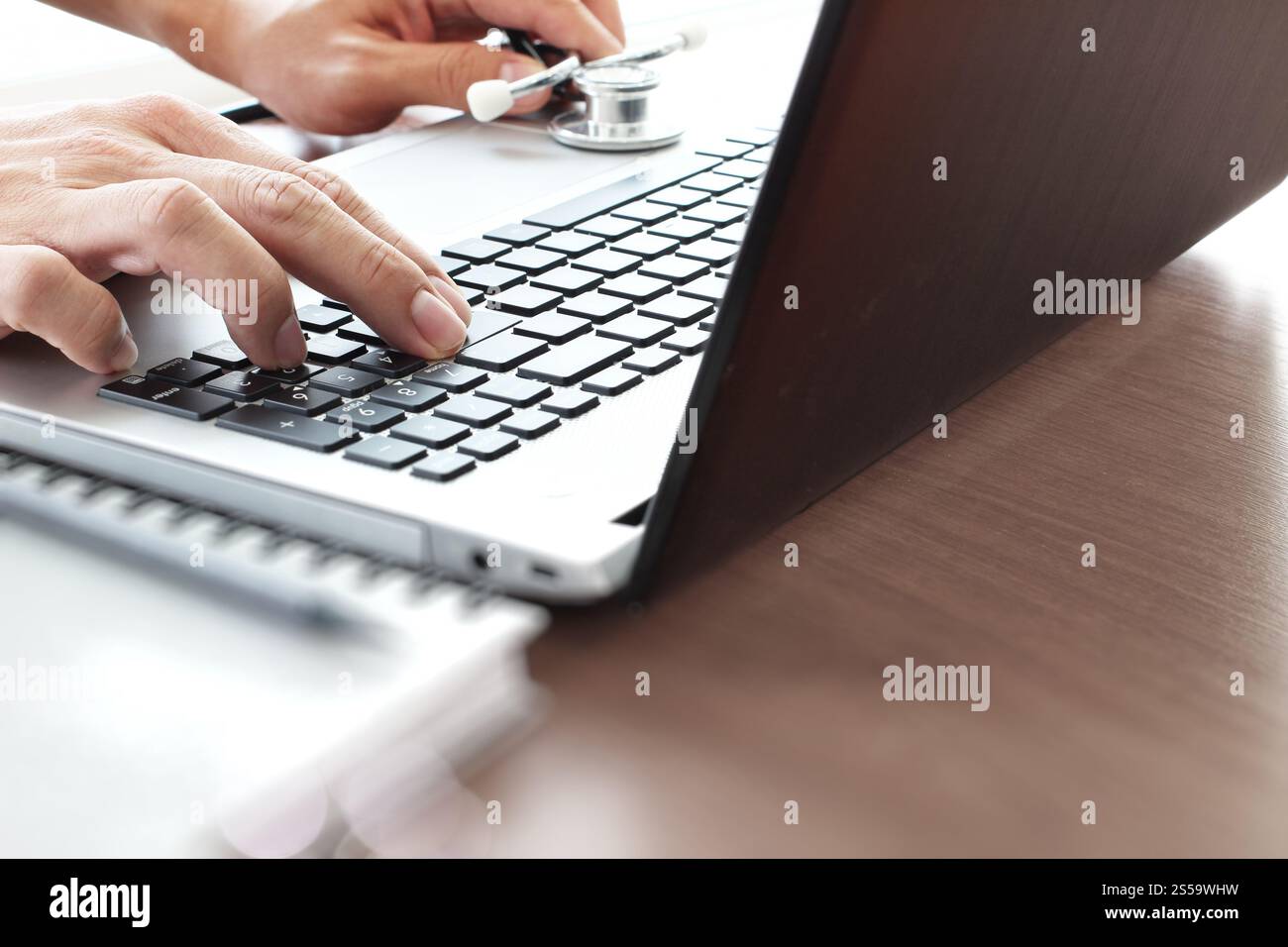 Doctor working with laptop computer in medical workspace office as ...