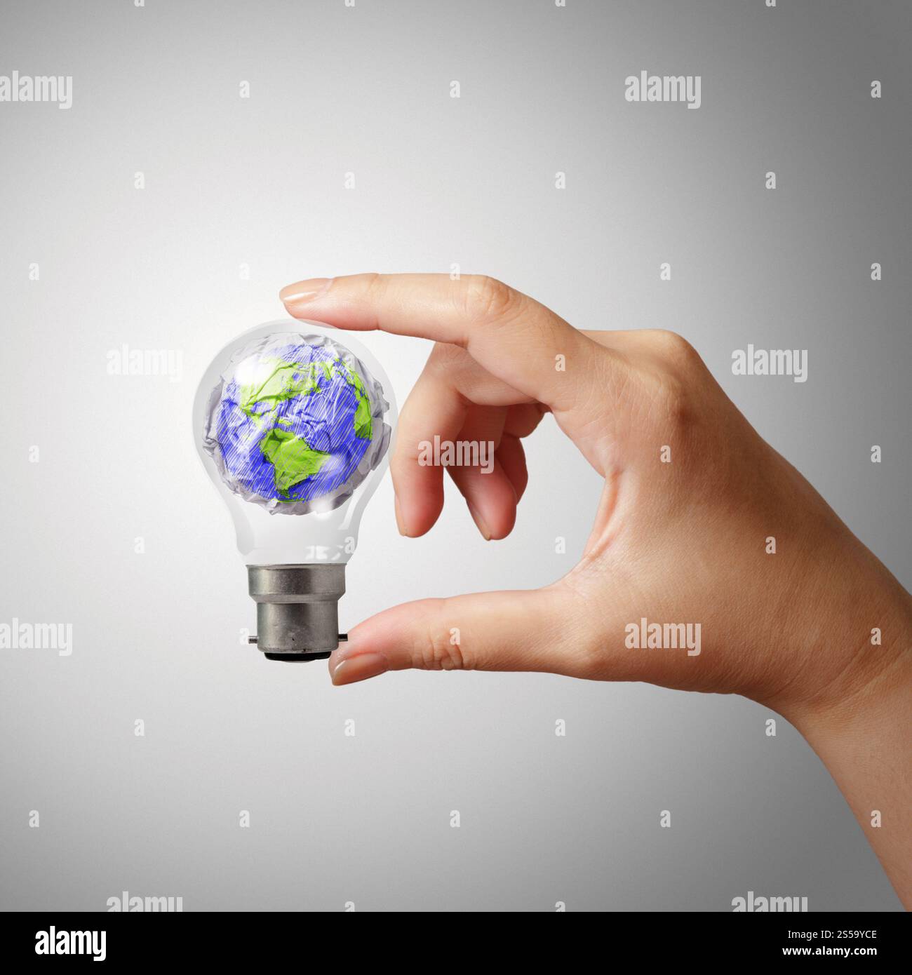 hand showing crumpled world paper symbol in light bulb as concept Stock ...