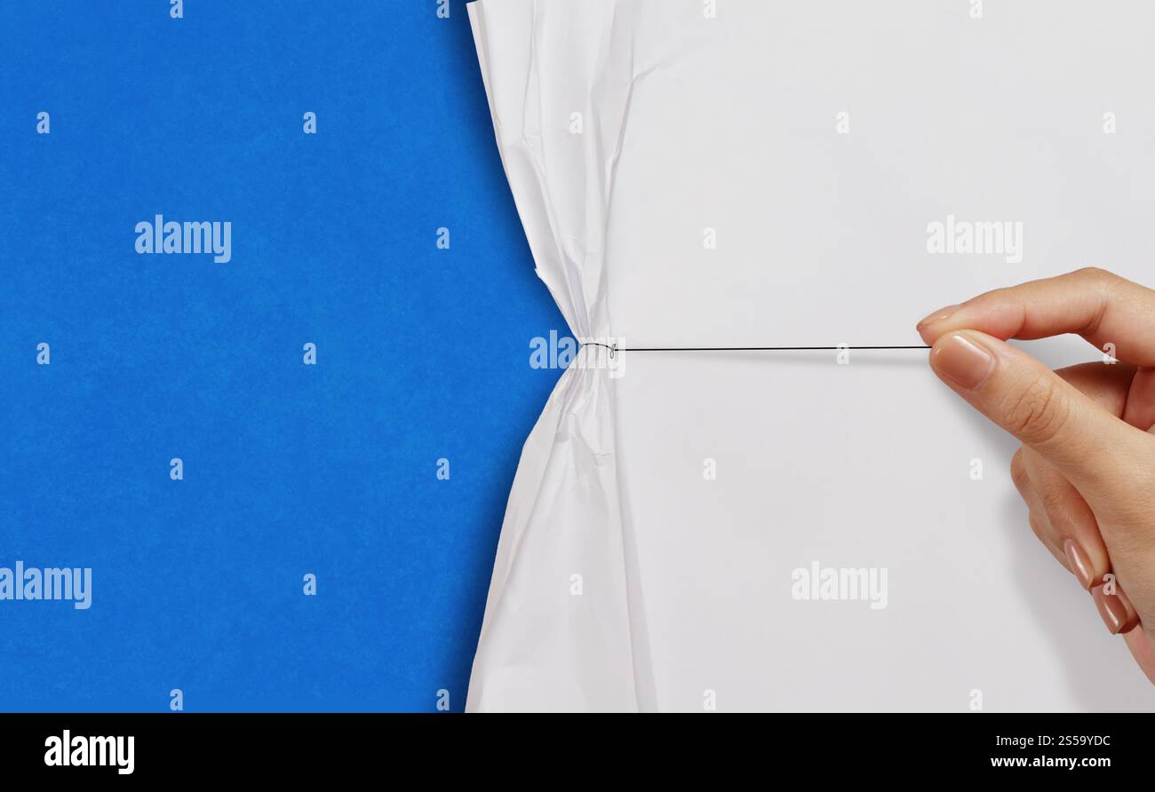 hand pull rope open wrinkled paper show blue background as business ...