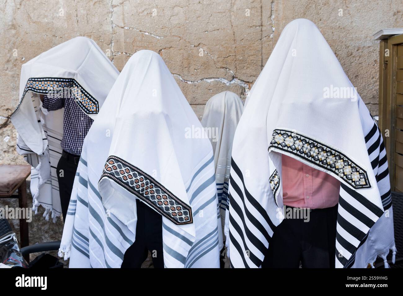 Cohanim or Jewish priests cover their heads with their prayer shawls ...