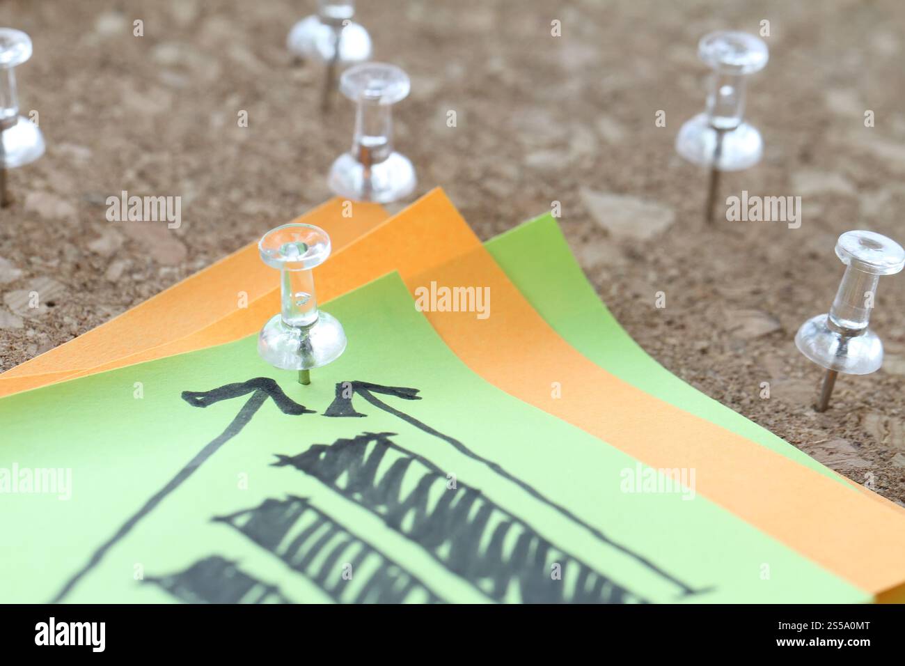 close up of pin and hand drawn business strategy graph chart on sticky ...