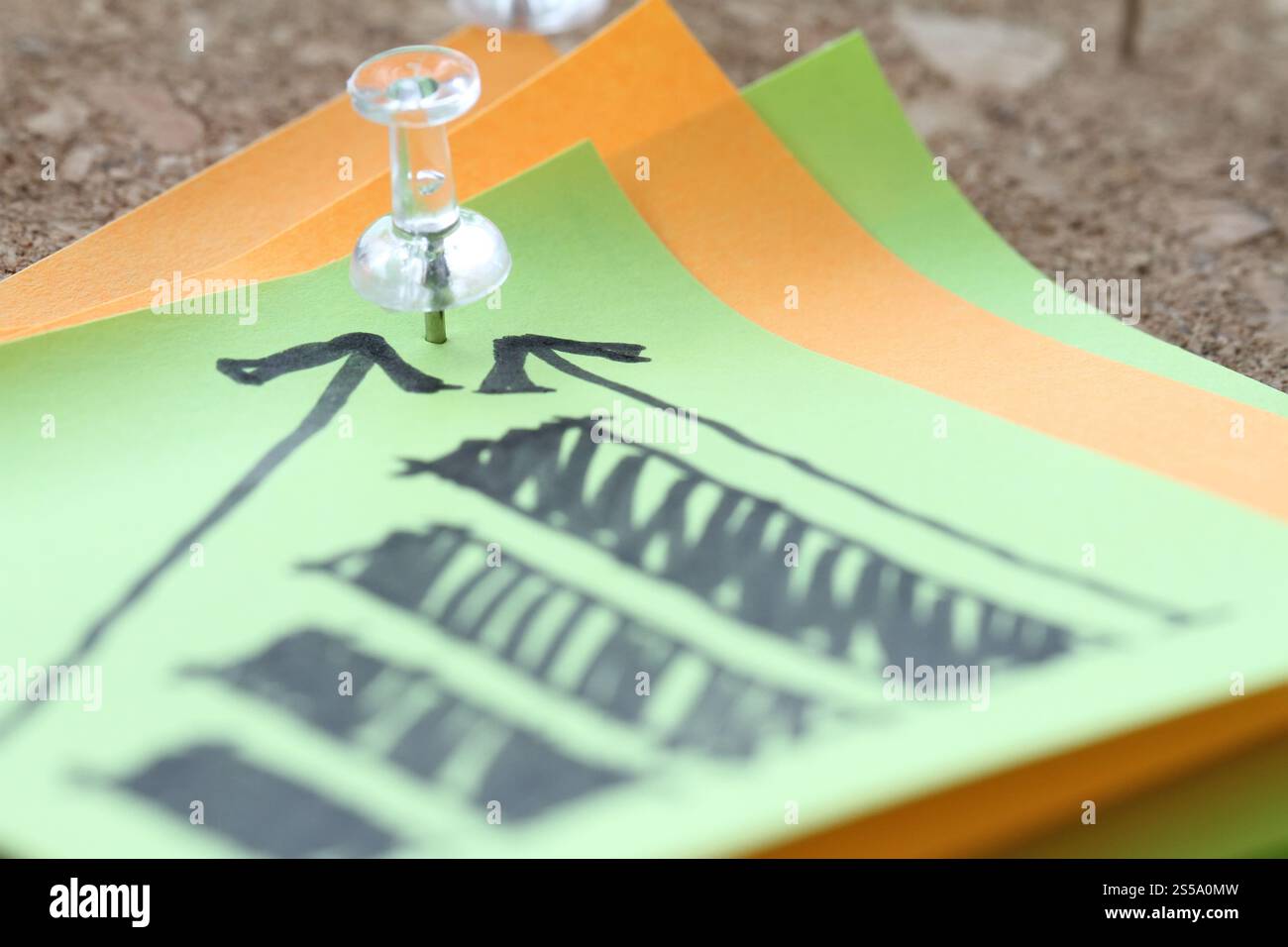 close up of pin and hand drawn business strategy graph chart on sticky ...