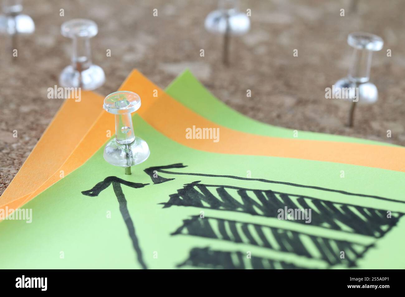 close up of pin and hand drawn business strategy graph chart on sticky ...