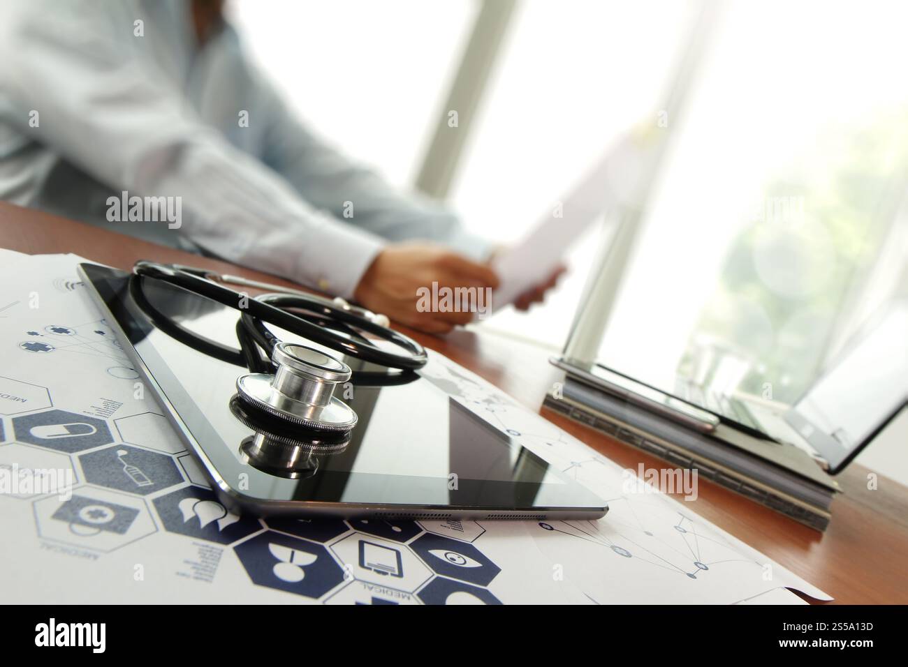 Doctor working with digital tablet and laptop computer in medical ...