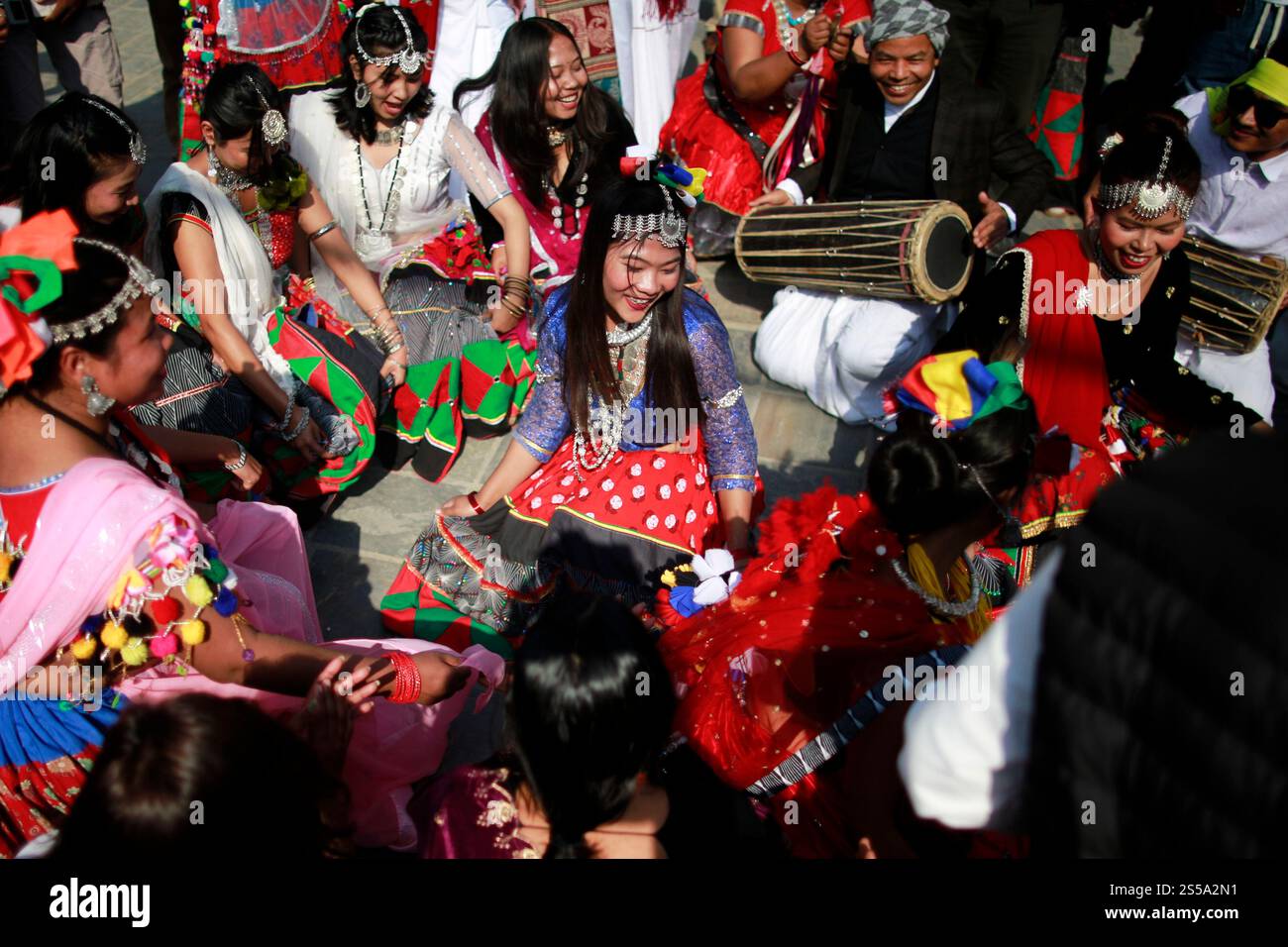 Kathmandu, Nepal. 13th Jan, 2025. People from the ethnic Tharu community dressed in traditional ...