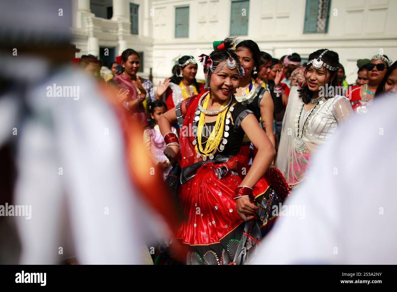 Kathmandu, Nepal. 13th Jan, 2025. People from the ethnic Tharu community dressed in traditional ...