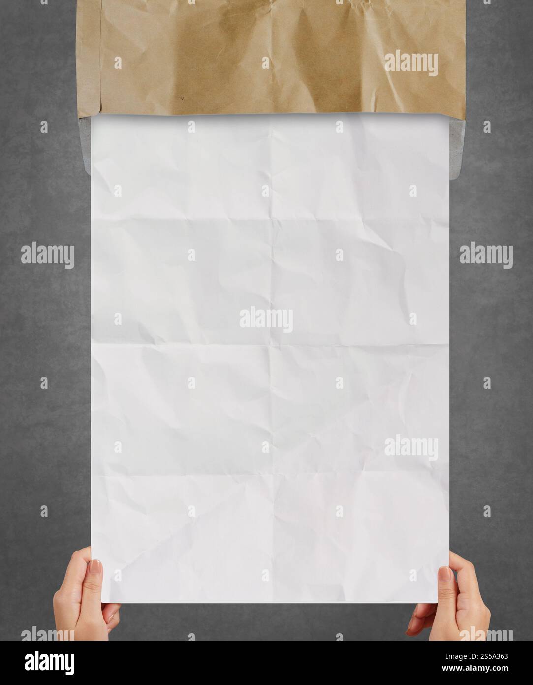 hand pulling crumpled paper from recycle envelope as concept background ...