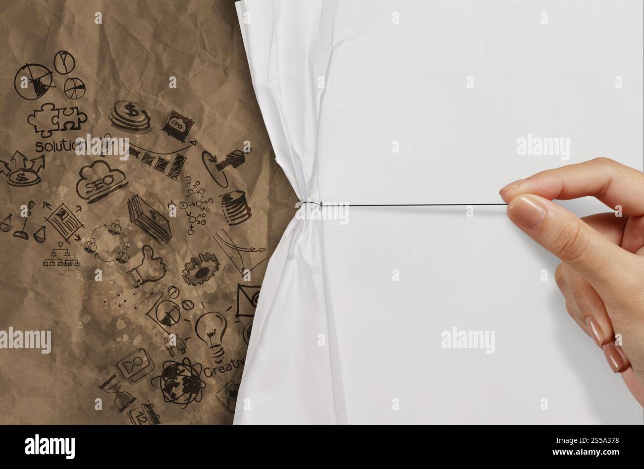 business hand draws rope open wrinkled paper show business strategy on ...