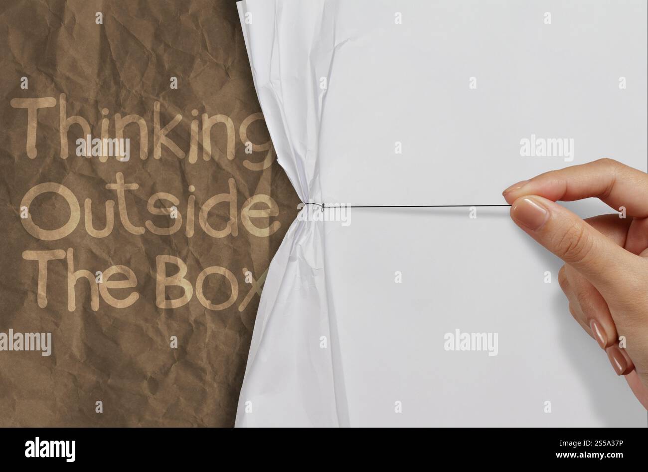 hand pull wrinkled paper show think outside the box with crumpled paper ...
