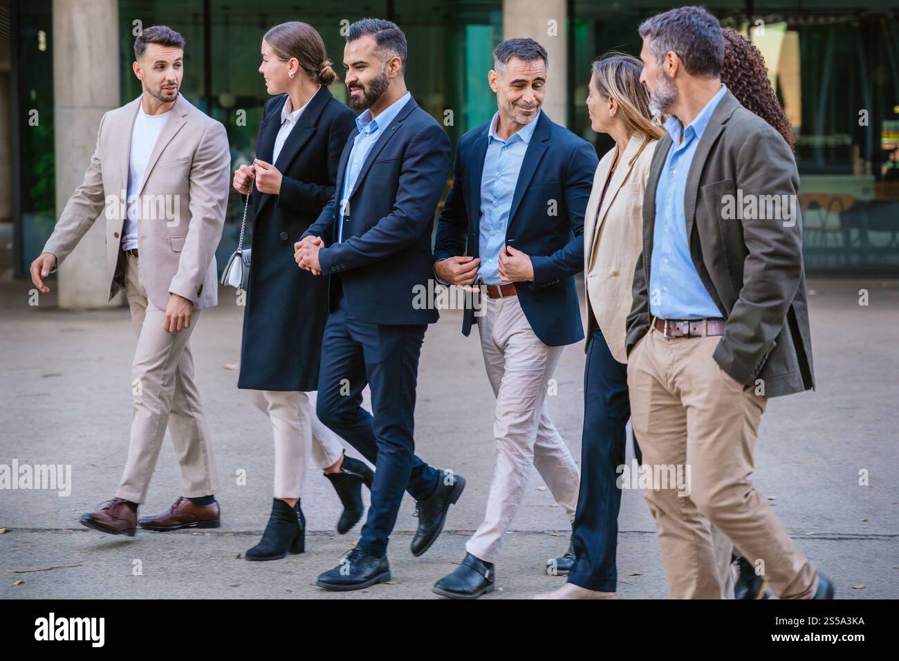 Business Team Walking and Talking Outdoors in Urban Setting Stock Photo ...