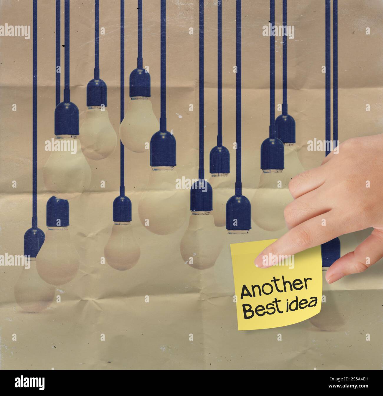 hand touch sticky note with another idea light bulb on crumpled paper ...