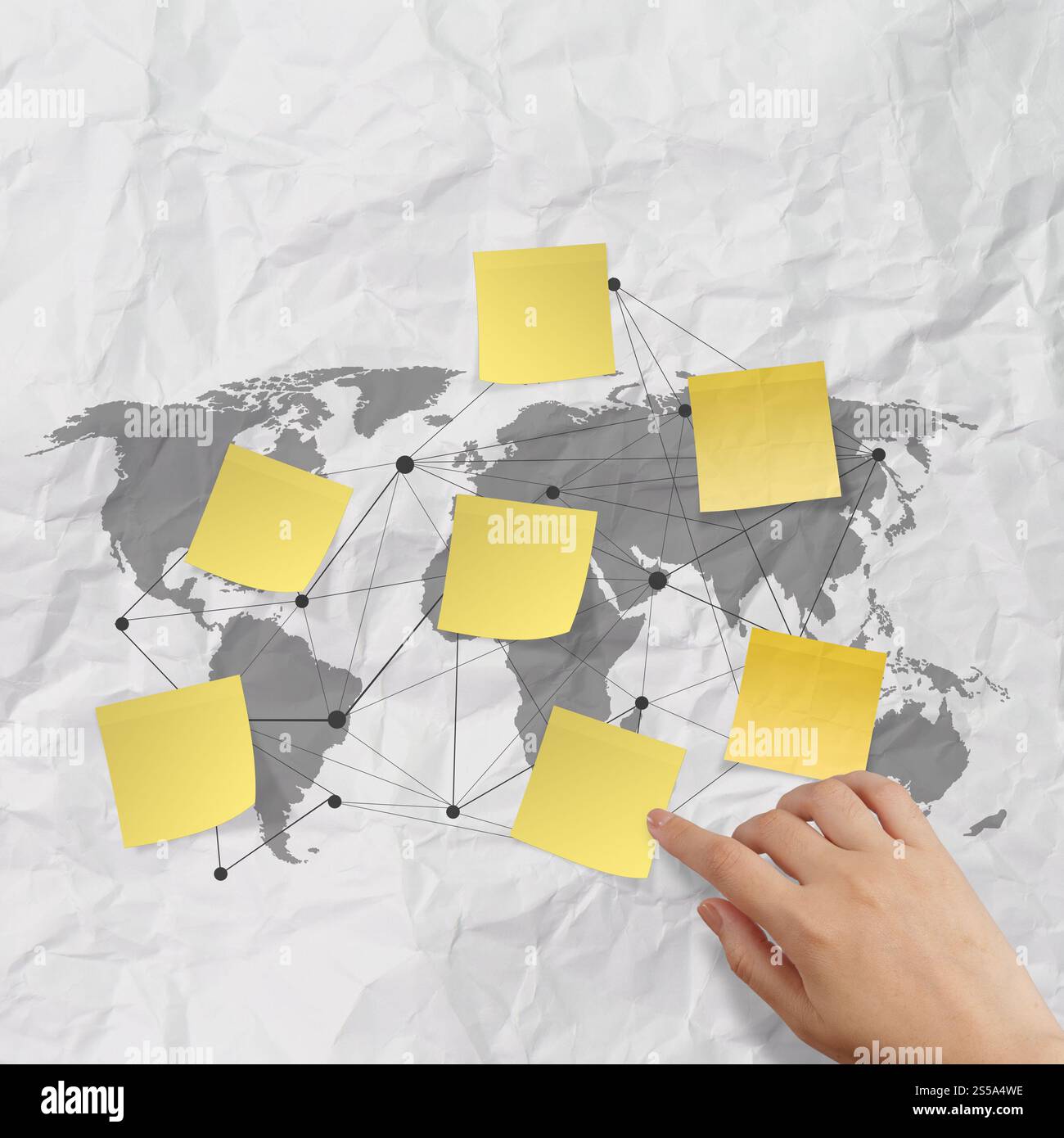 hand pushing sticky note social network icon on crumpled paper ...