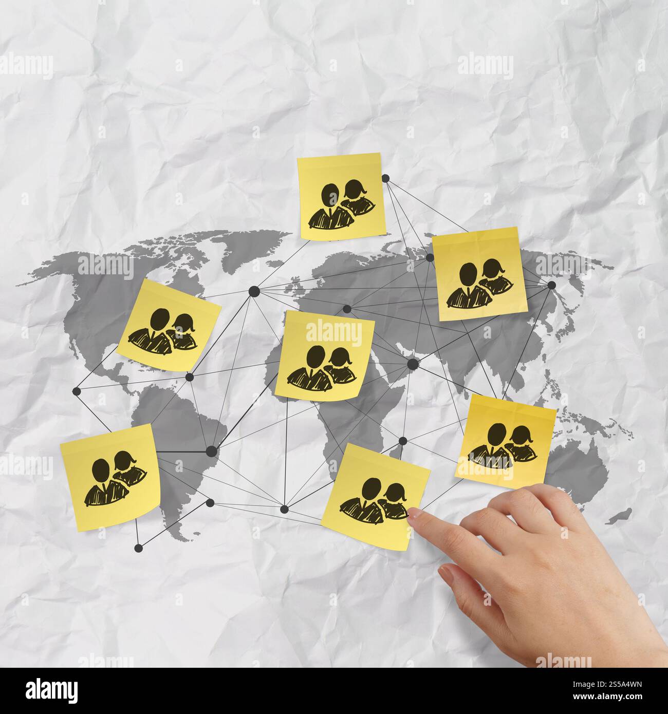 hand pushing sticky note social network icon on crumpled paper ...
