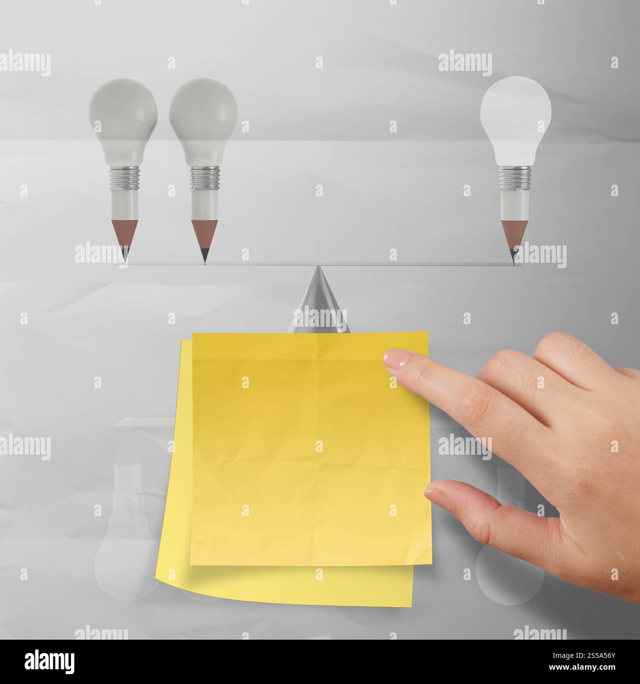 sticky note with false balance of pencil lightbulb on crumpled paper ...