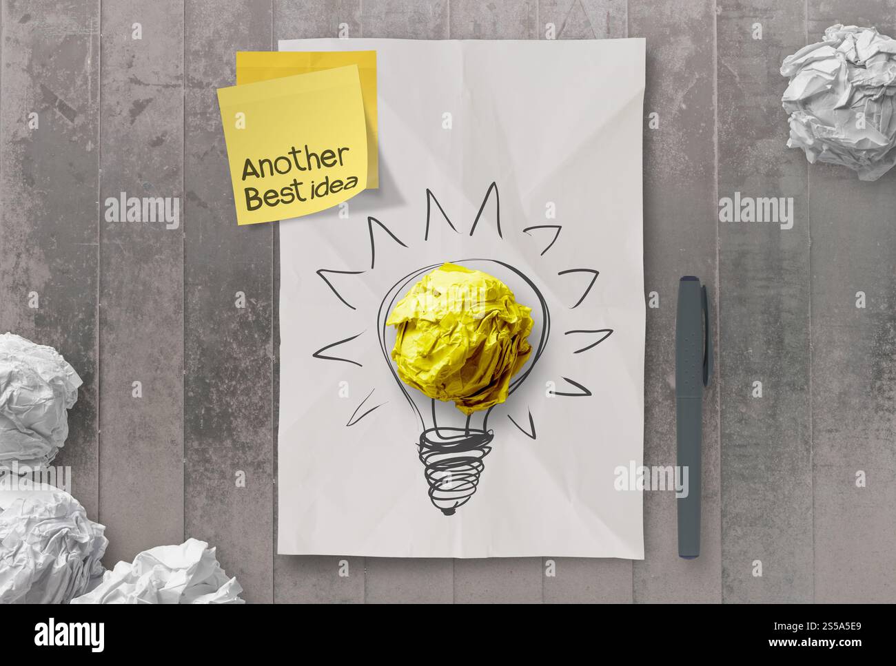 sticky note with another idea light bulb on crumpled paper as creative ...