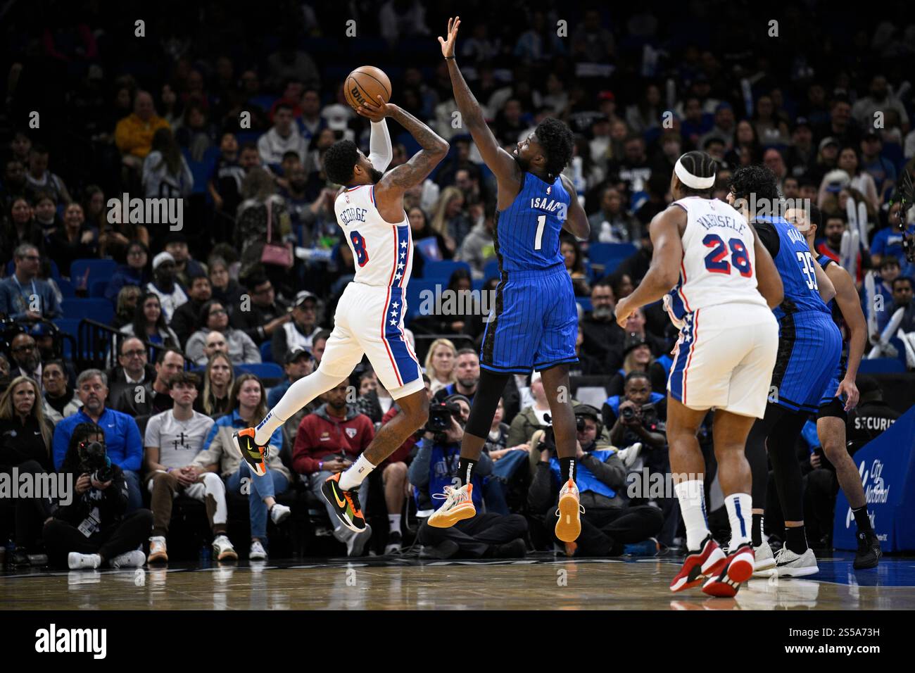 Philadelphia 76ers forward Paul George (8) is defended by Orlando Magic ...